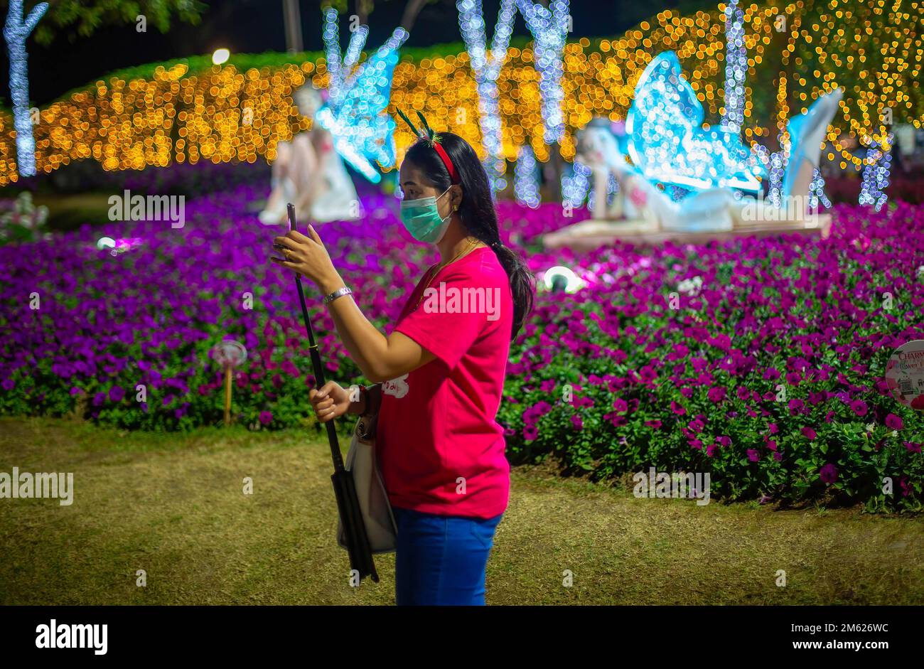 A woman seen taking selfies with their mobile phones with illuminations lighting during the New ...