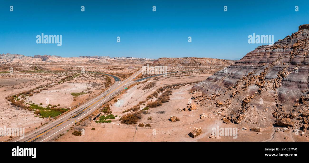 Panoramic image of a lonely, seemingly endless road in the desert of ...