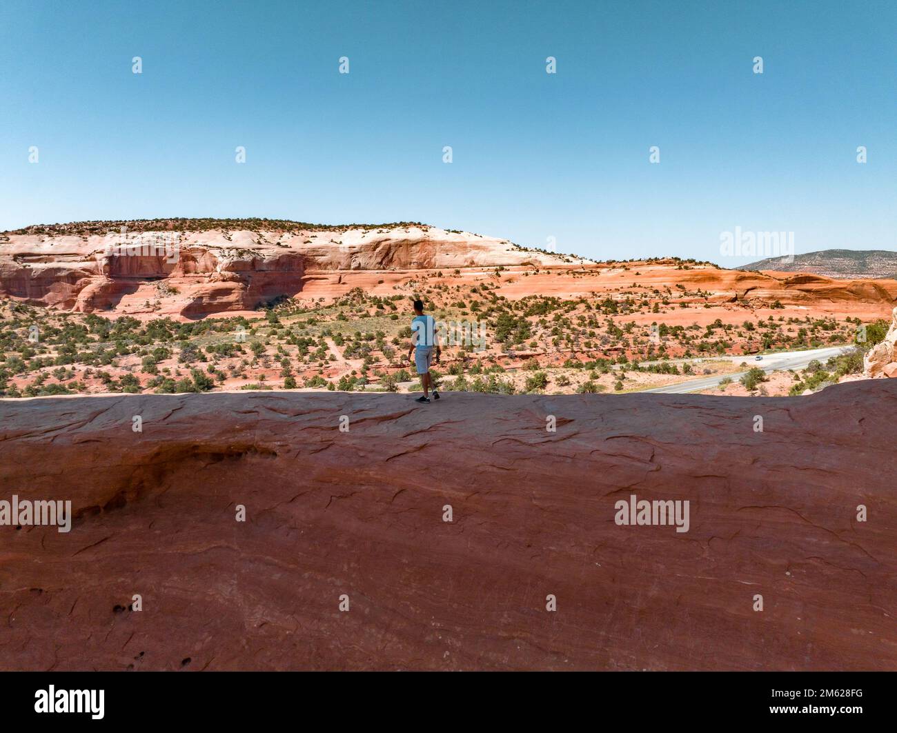 Young man standing in the Arches National Park in Arizona, USA Stock ...