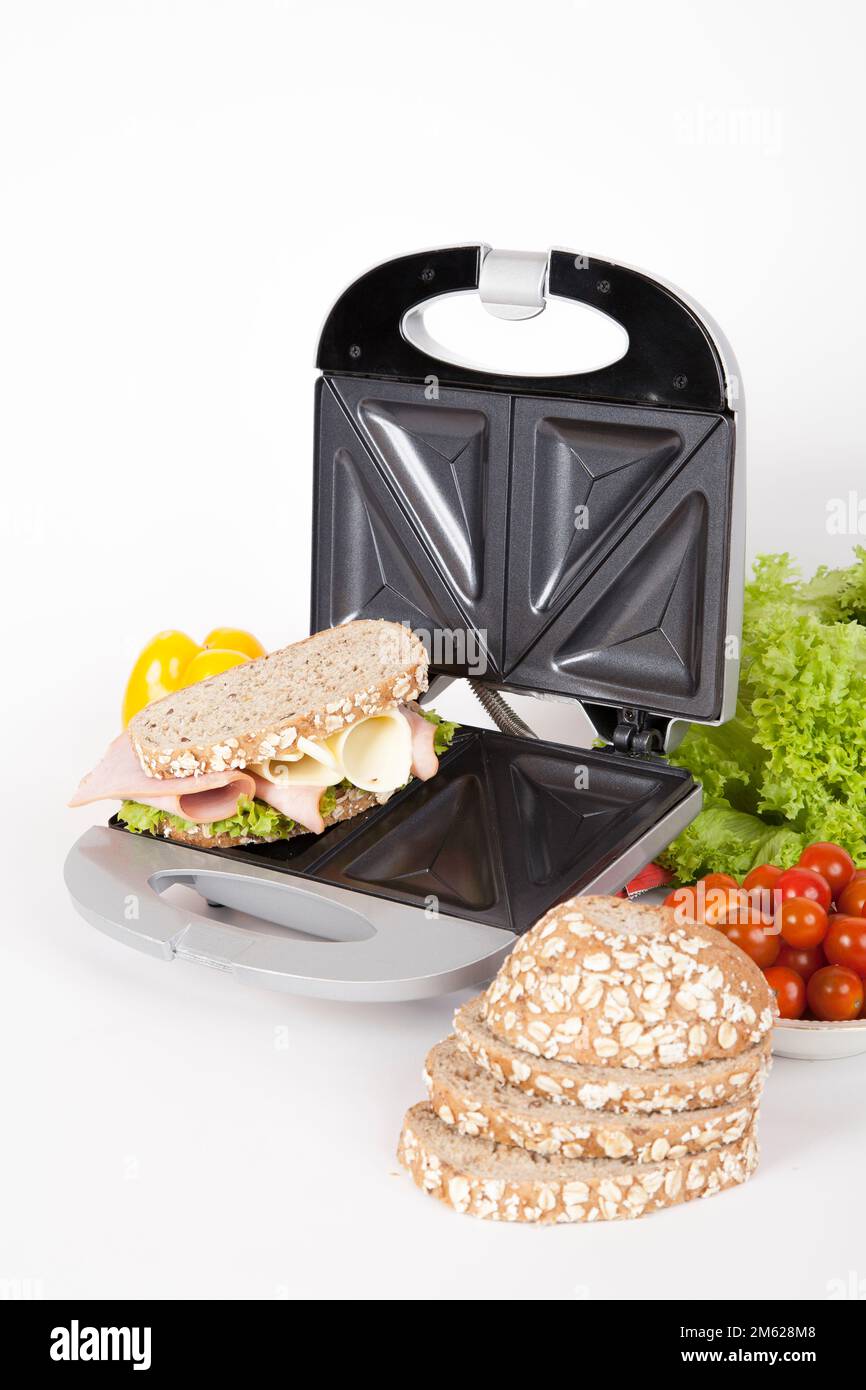 Sandwich maker gray with food; Photo on white background Stock Photo ...
