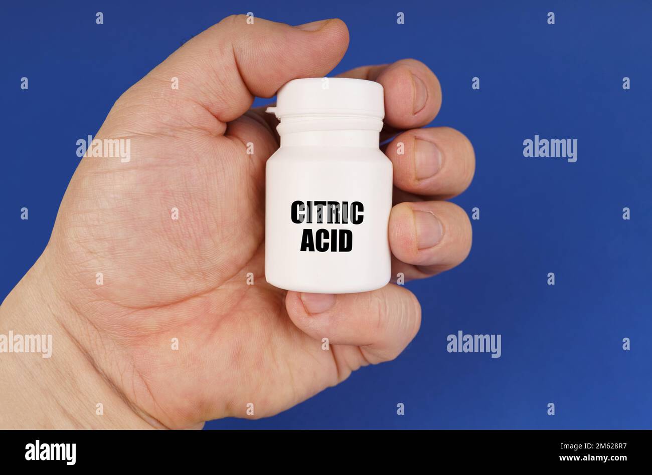 Pharmacology concept. On a blue background in the hands of a man is a ...