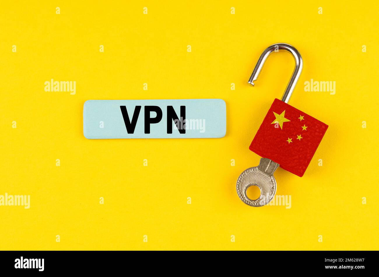 On a yellow surface, an open lock with the image of the flag of China ...