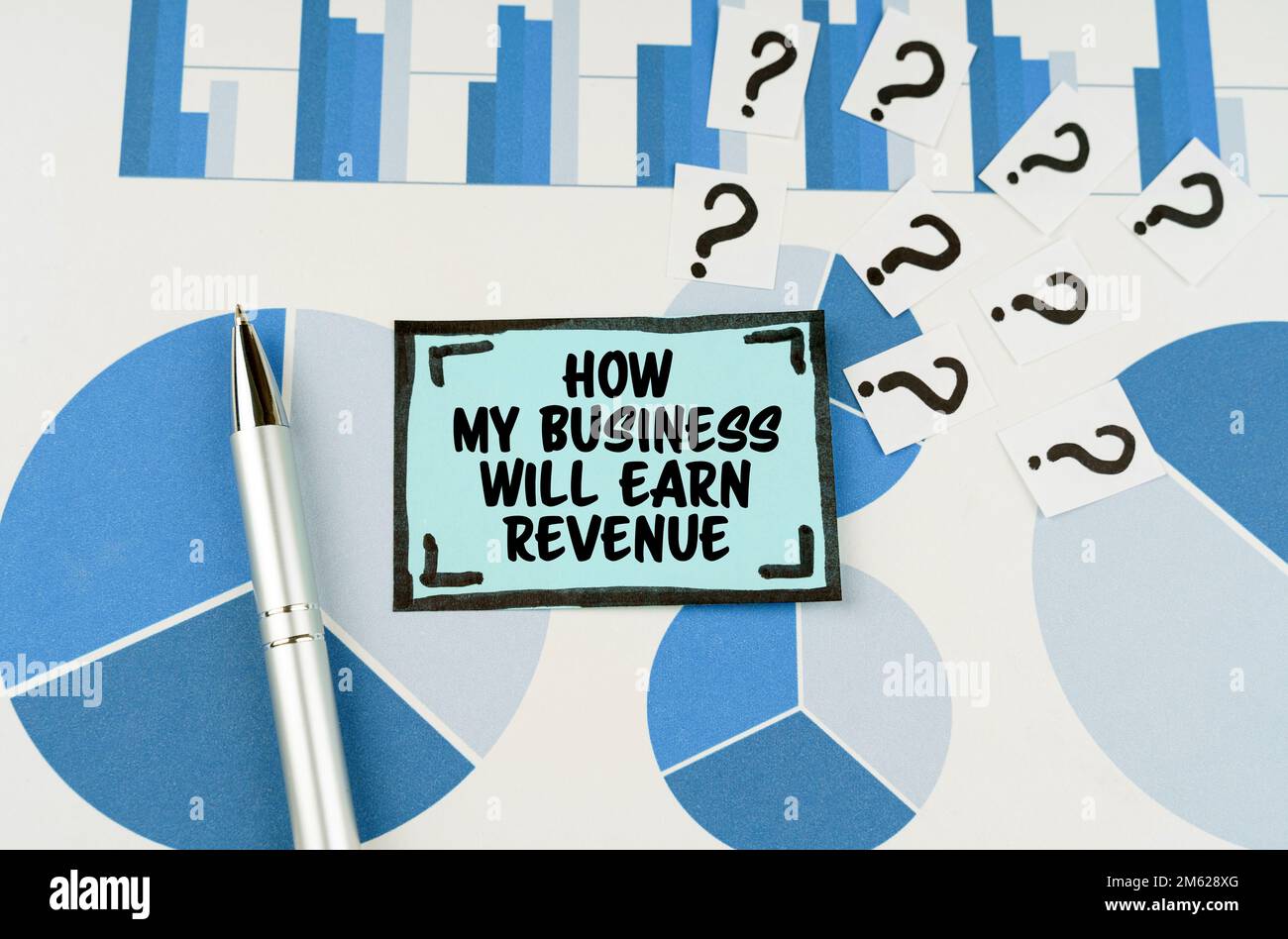 business question concept. On the blue diagrams lies a pen, questions ...