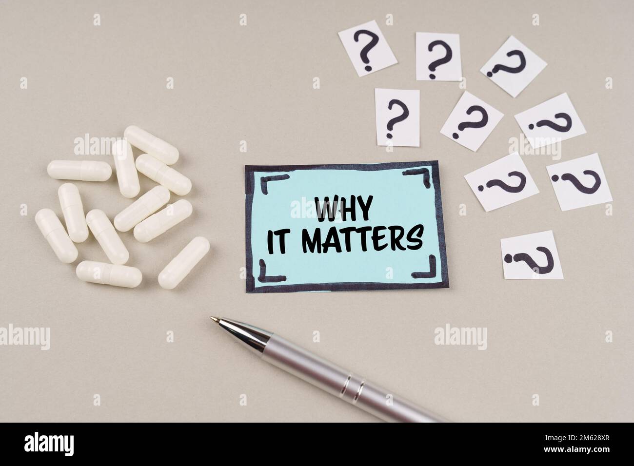 Medical concept. On a gray surface there are question marks and a blue ...