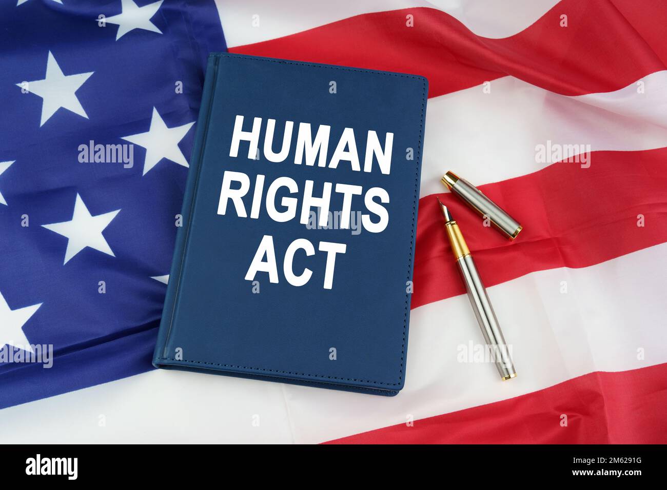 Law concept. On the US flag lies a pen and a book with the inscription ...