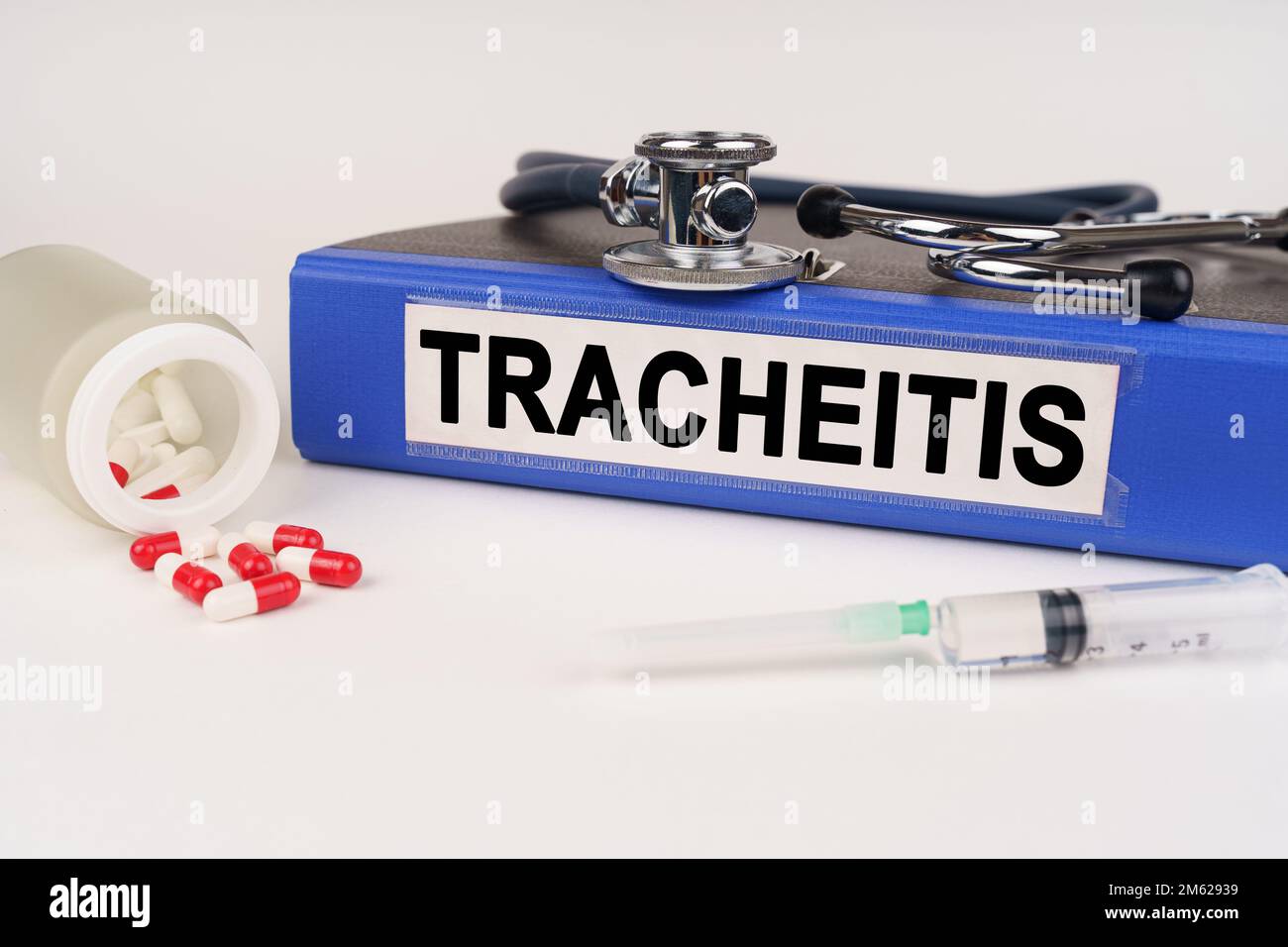 Medical concept. On a white surface there are pills, a syringe, a ...