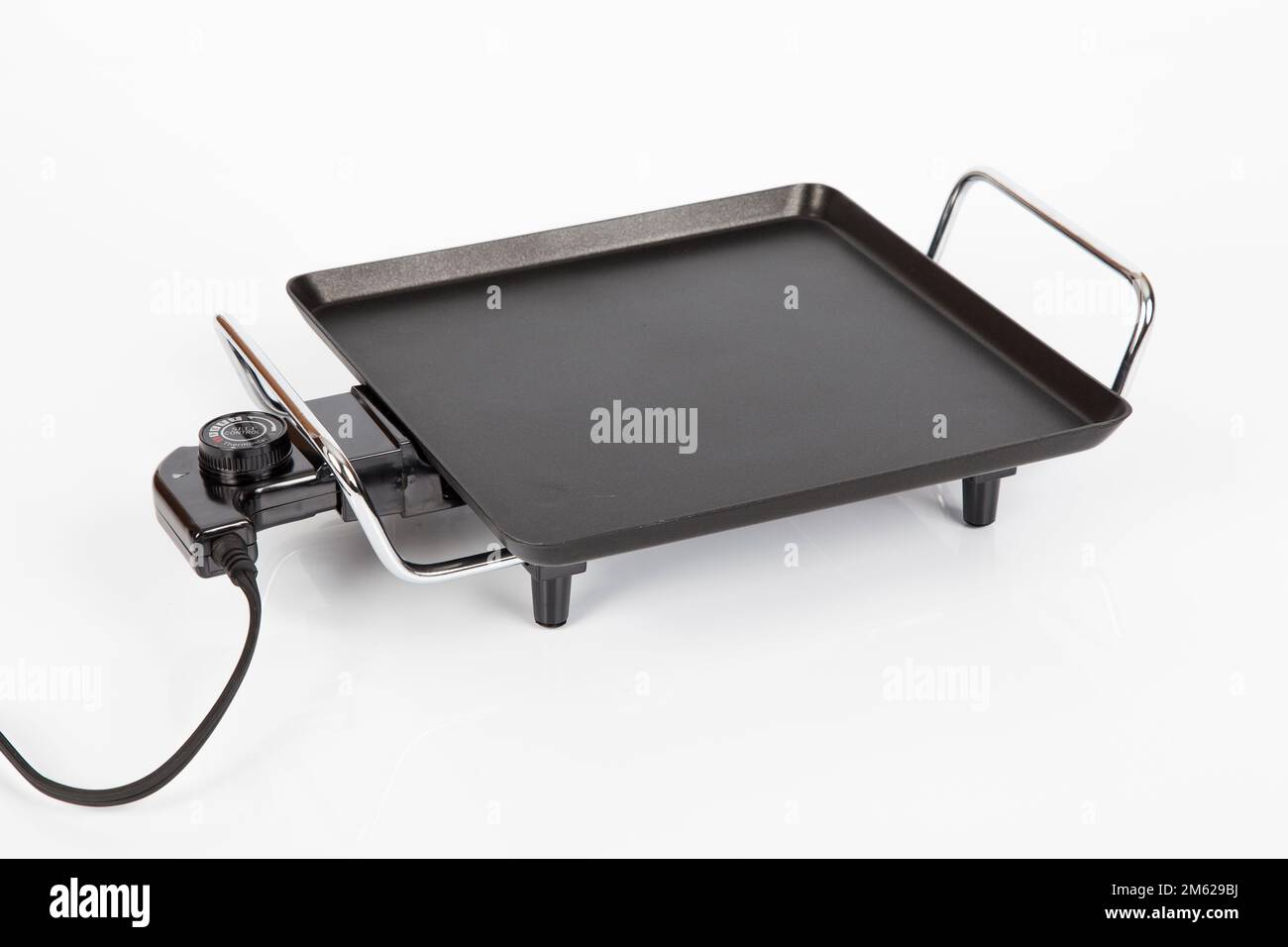 Electric griddle for cooking; photo on white background Stock Photo - Alamy