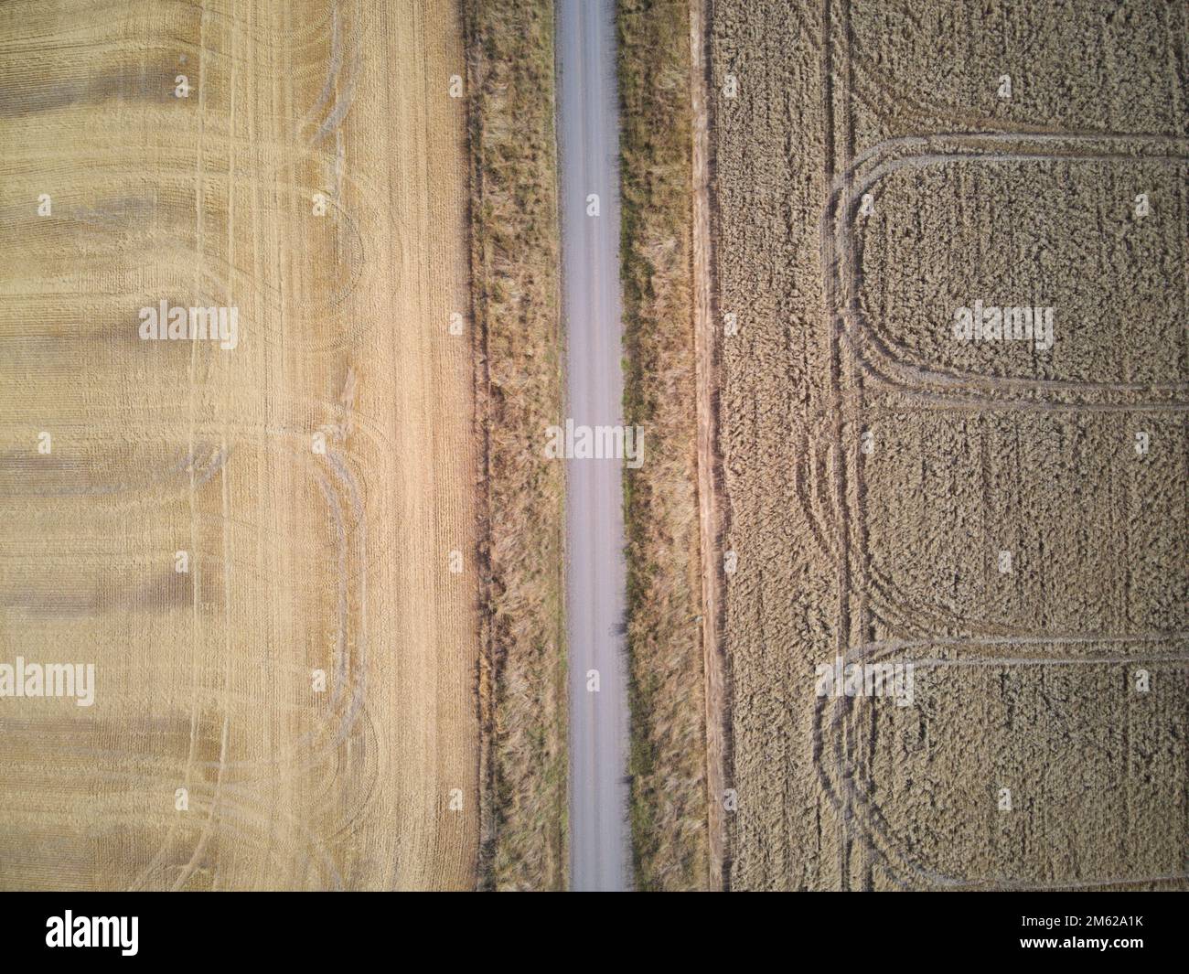 Road in the countryside aerial view showing wheat field patterns and ...