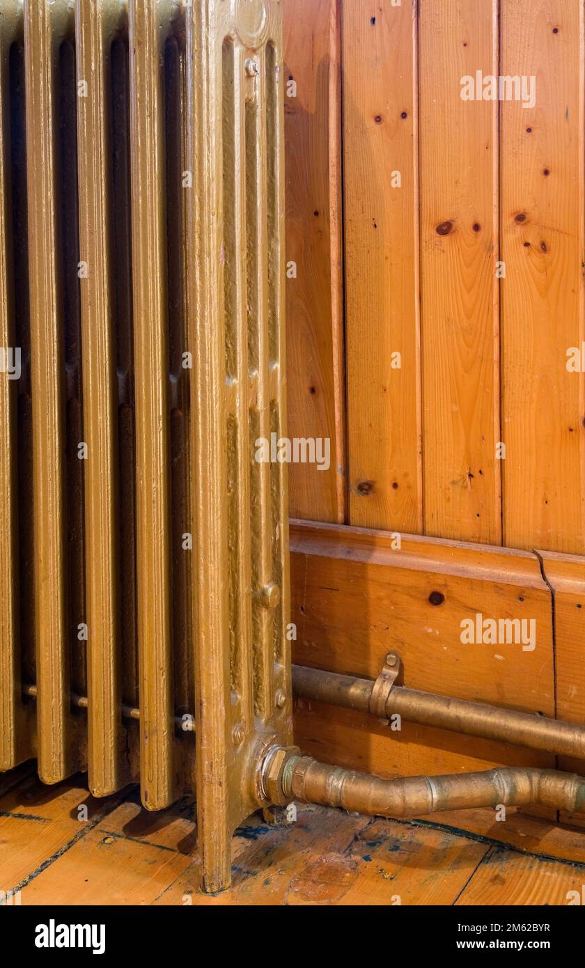 Close-up of hot water heating radiator inside old 1920s cottage style ...