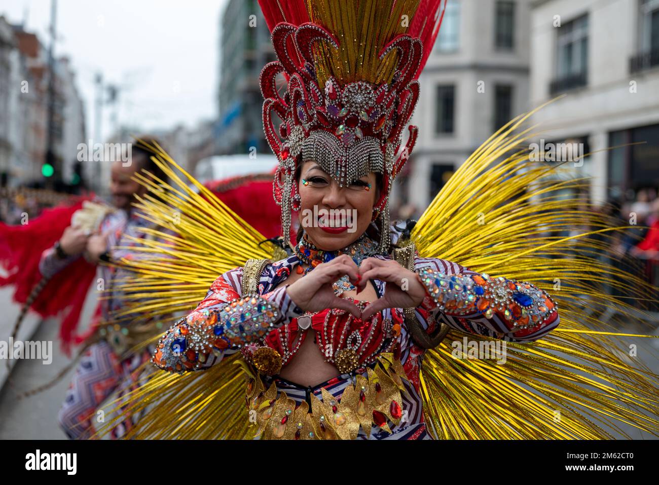London, UK. 01st Jan, 2023. A performer in colourful costume takes part ...