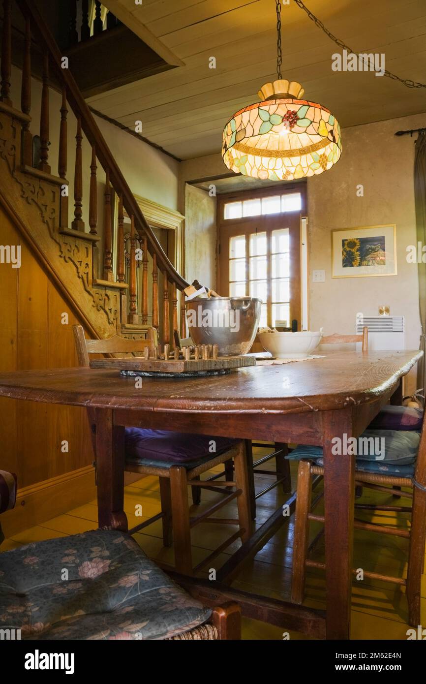 Long antique brown stained wooden dining table and chairs in dining ...