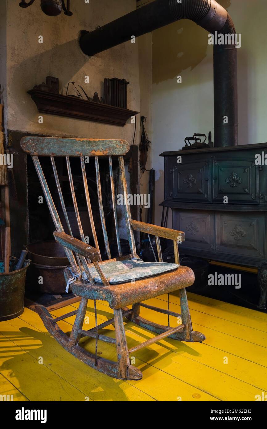 Antique rocking chair and black cast iron wood burning stove in front ...