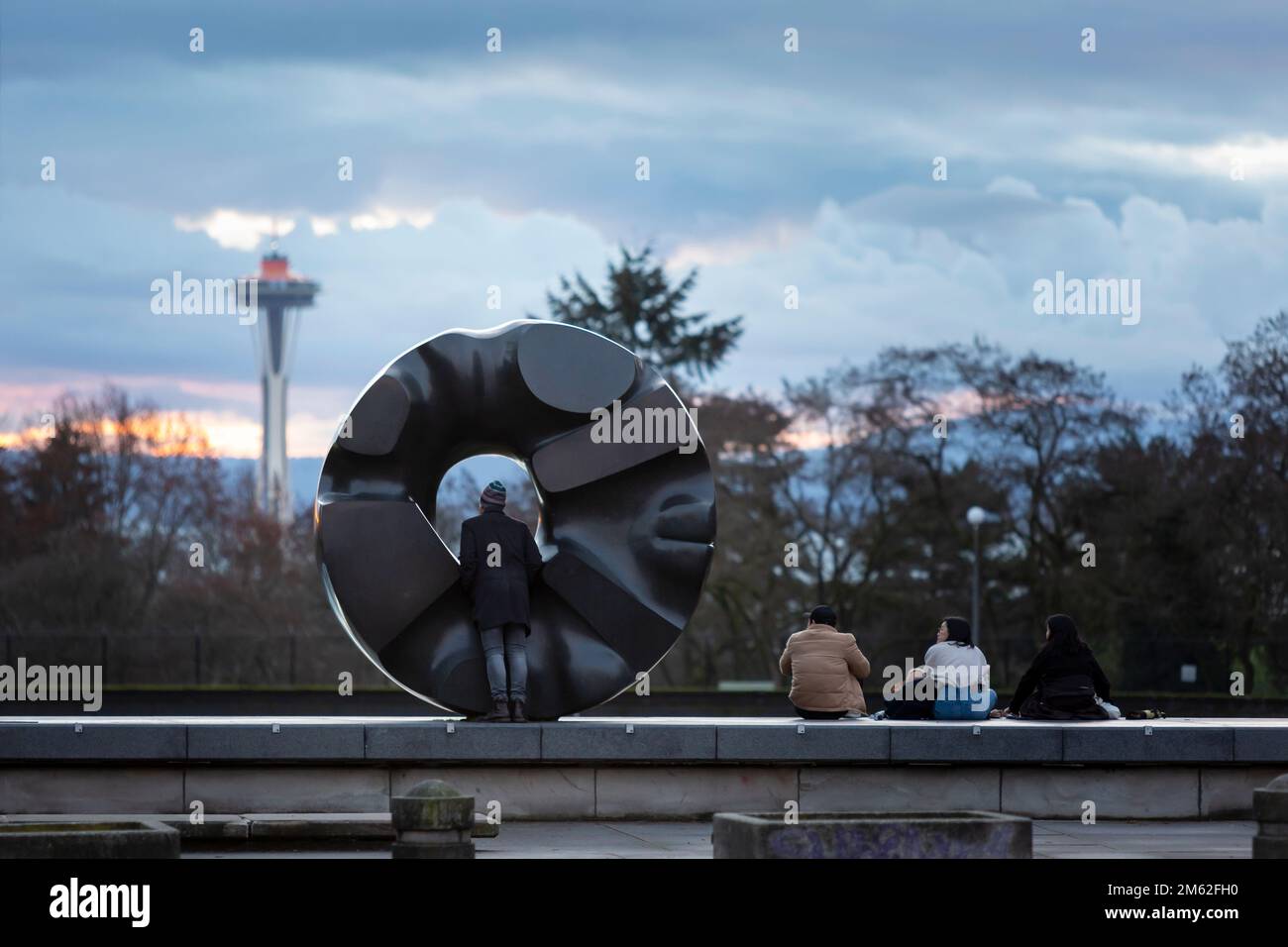 Visitors enjoy the sunset at Isamu Noguchi’s landmark “Black Sun ...
