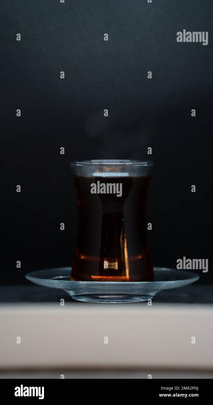 glass of turkish and arabic tea with a cup of coffee on a black ...