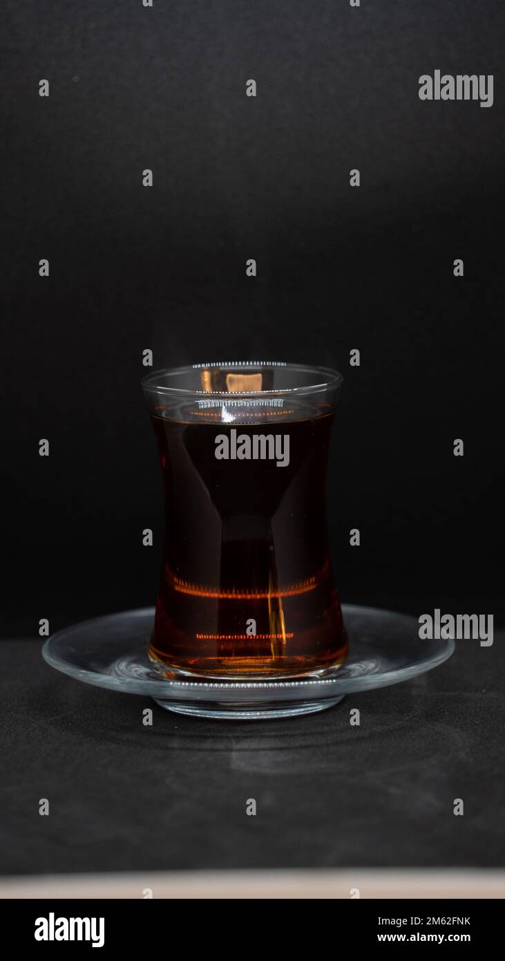 glass of turkish and arabic tea with a cup of coffee on a black ...