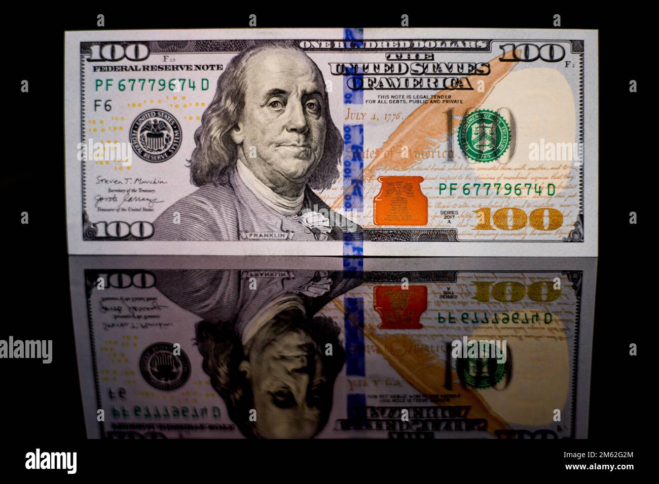 One hundred dollar bill with with reflection and black background Stock ...