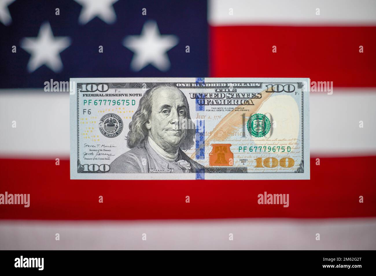 One hundred dollar bill with an American flag background Stock Photo ...