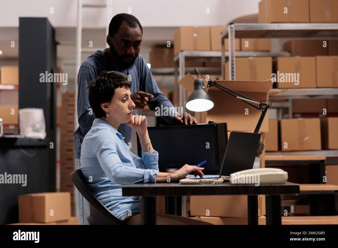 Supervisor woman analyzing metallic delivery order on laptop computer ...