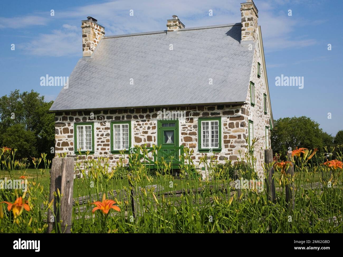 Old 1785 brown, beige and tan fieldstone cottage style home with green ...