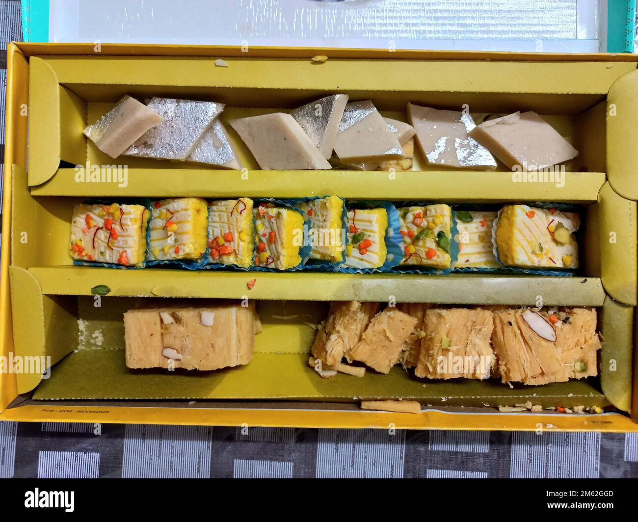 A top view of a box of delicious Indian sweets Stock Photo - Alamy
