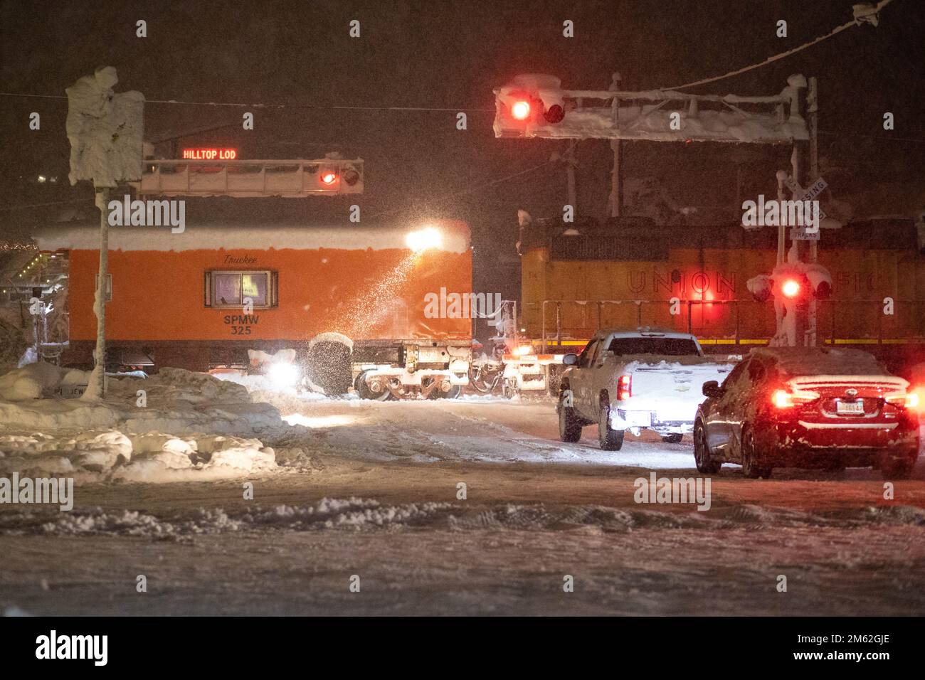 A Union Pacific train crosses the intersection during a blizzard. Heavy ...