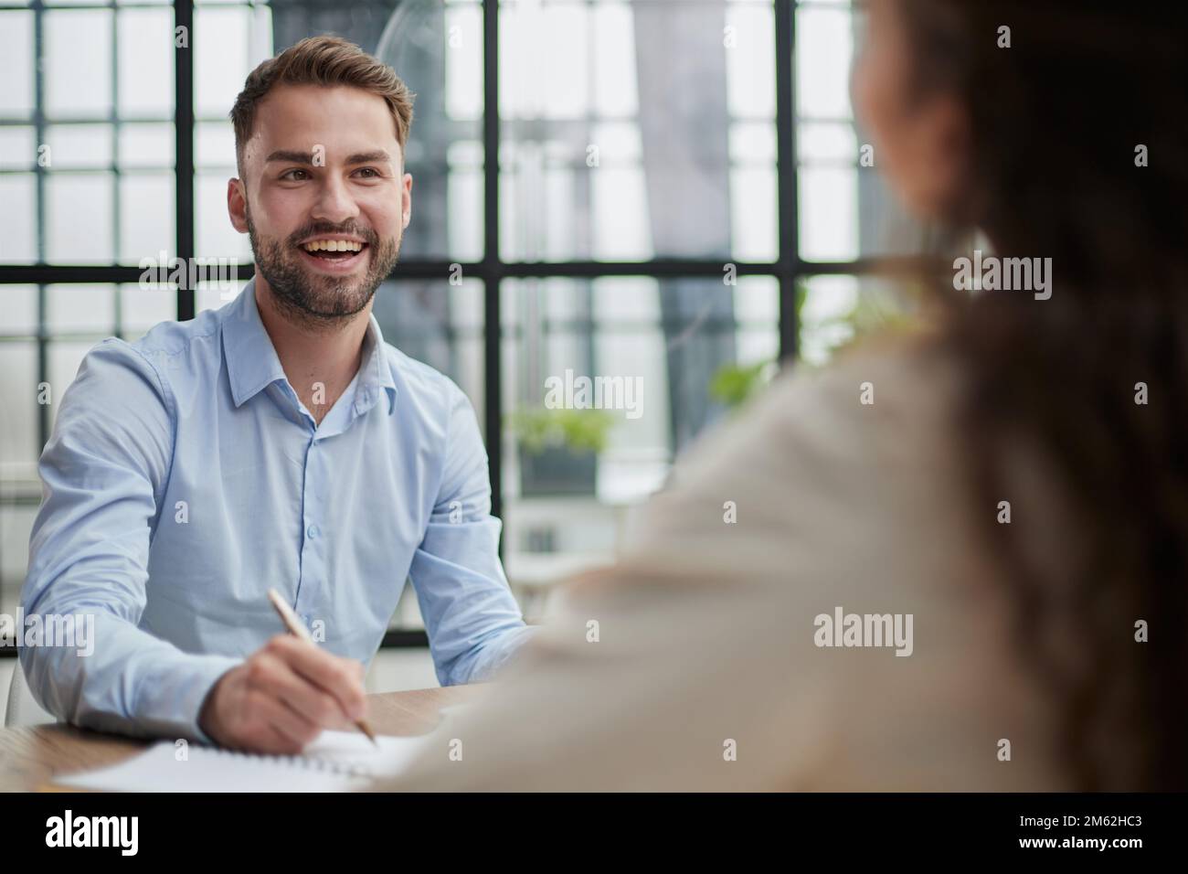 business man sitting at his desk in the office Stock Photo - Alamy