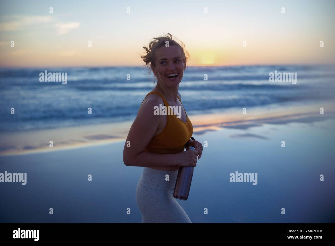 Woman healthy walking sunset beach hi-res stock photography and images ...