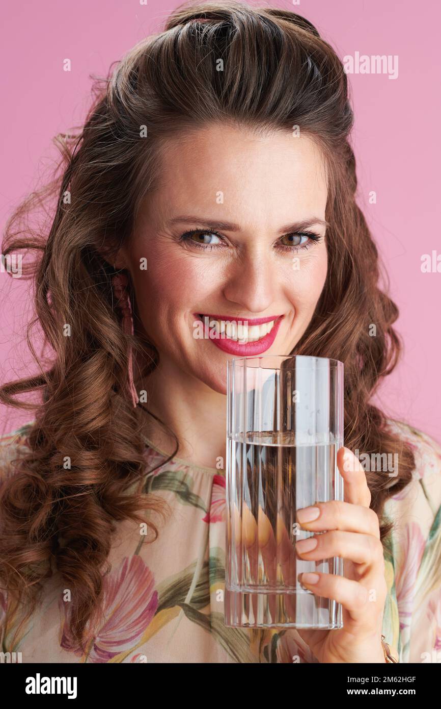 Portrait of smiling stylish 40 years old woman in floral dress with ...