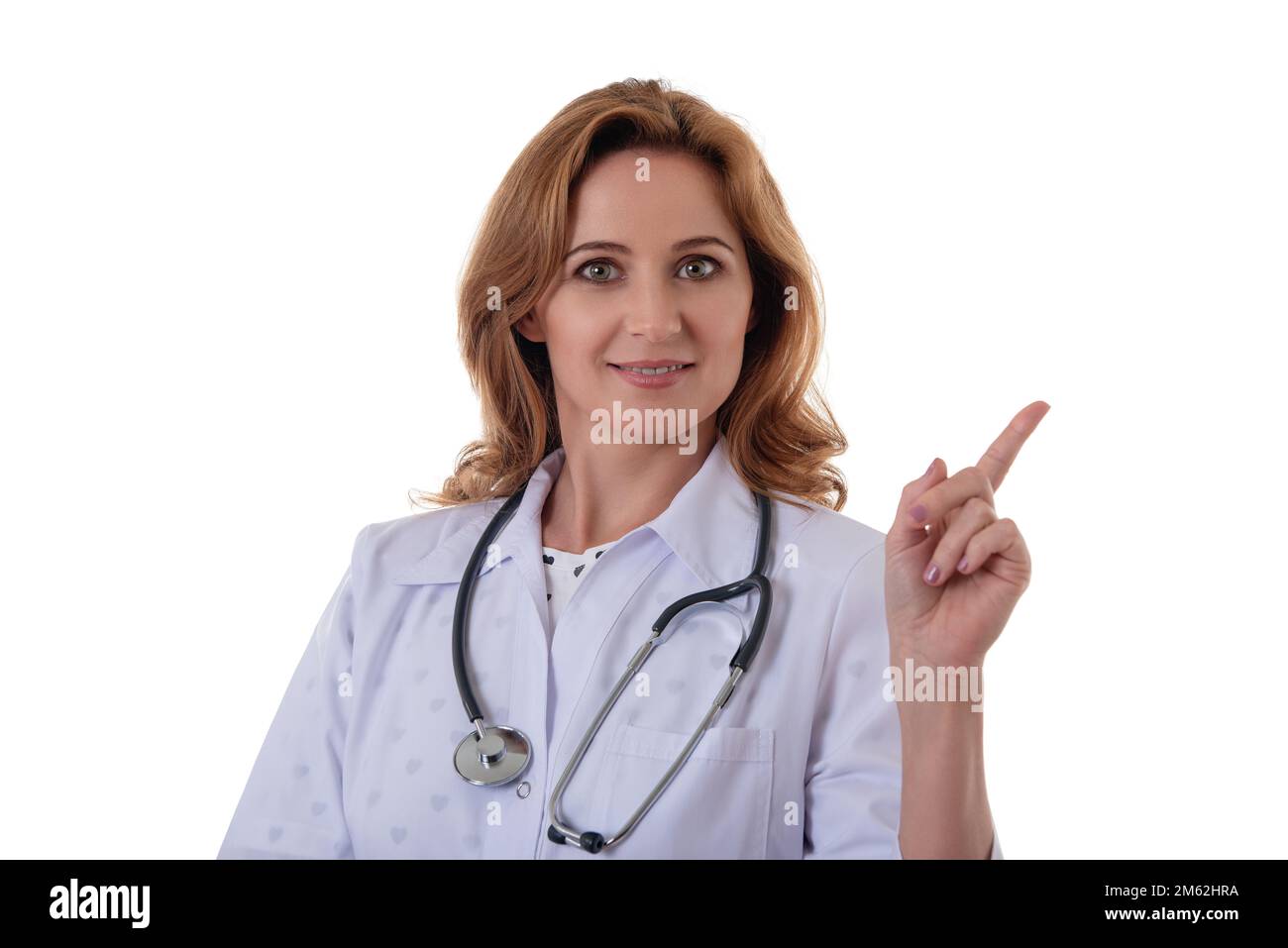 A beautiful young female doctor points her finger up isolated on white ...