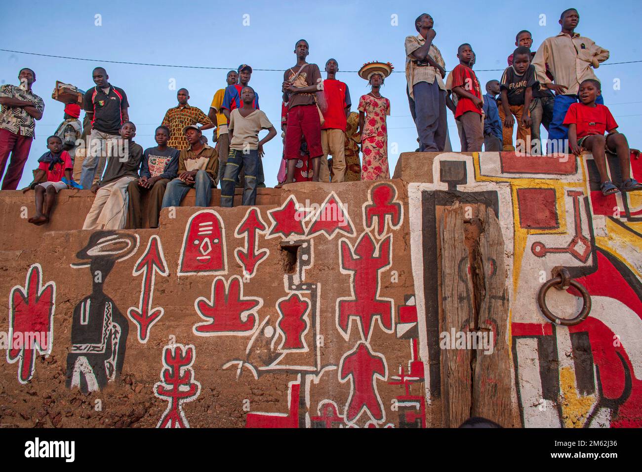 Group of people with african art mural in Segou ,Mali, West Africa ...