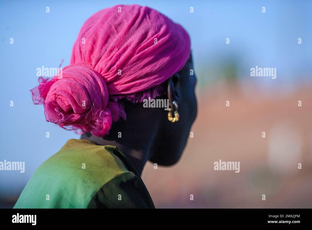 African woman with pink headscarf from behind Stock Photo - Alamy