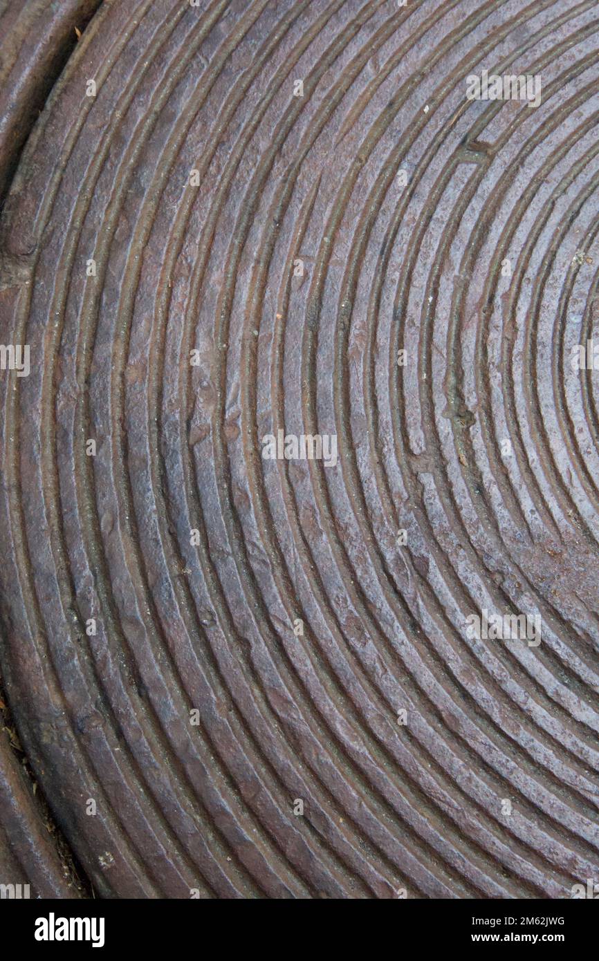 Sidewalk, metallic utility cap (old fashioned) with concentric circles ...