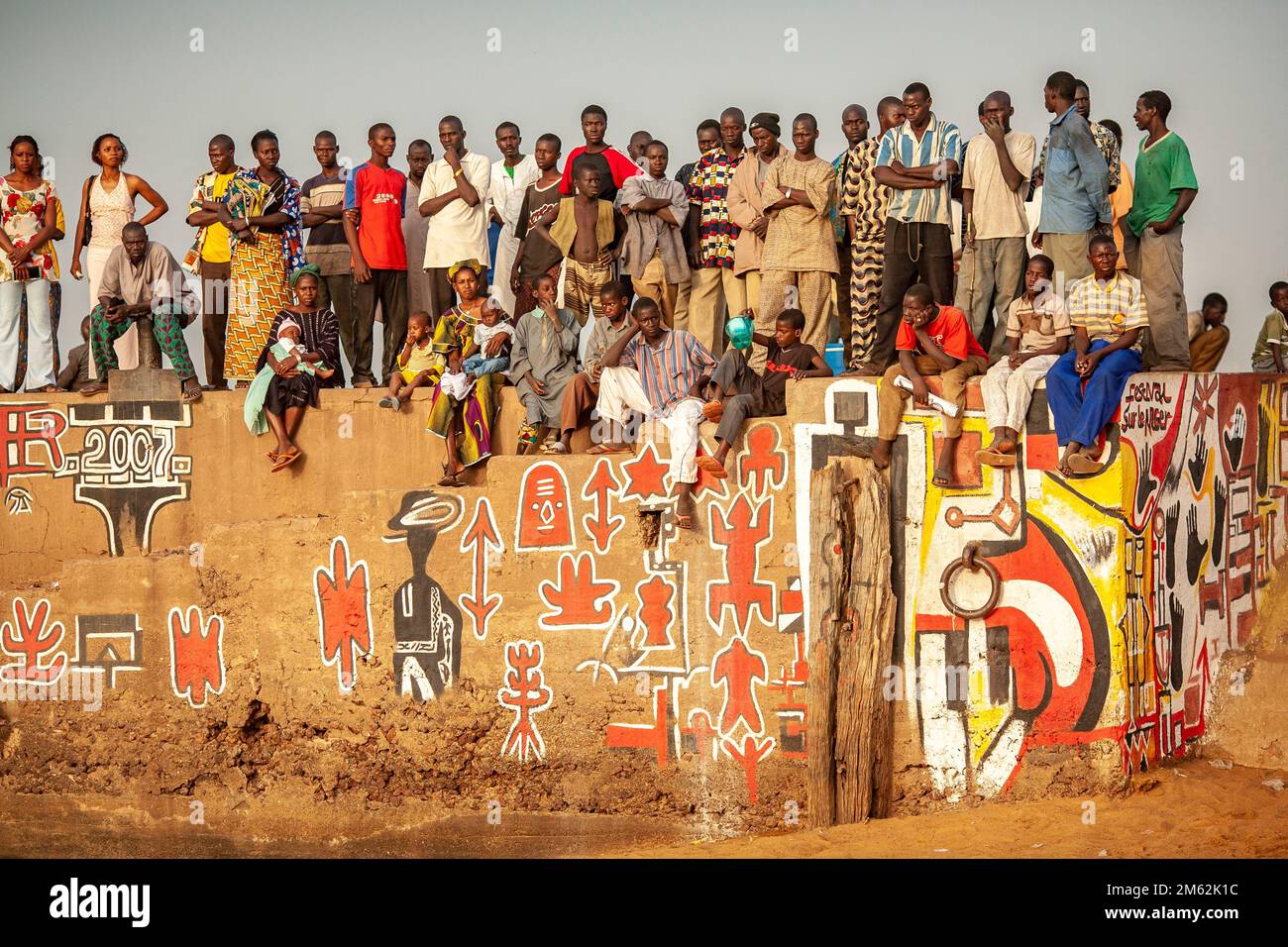 Group of people with african art mural in Segou ,Mali, West Africa ...