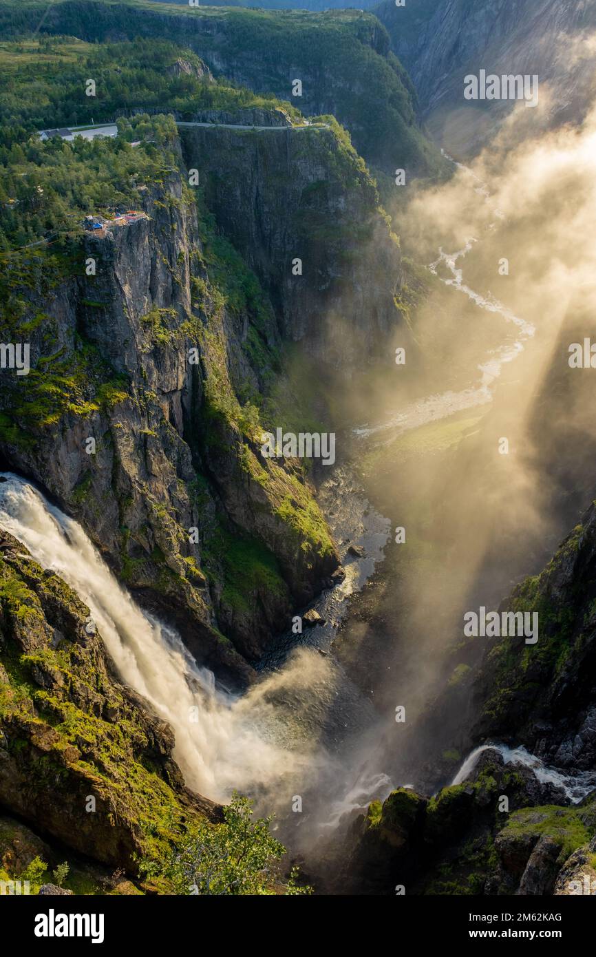 Amazing sunbeams passing through the mist created by the Voringfossen ...