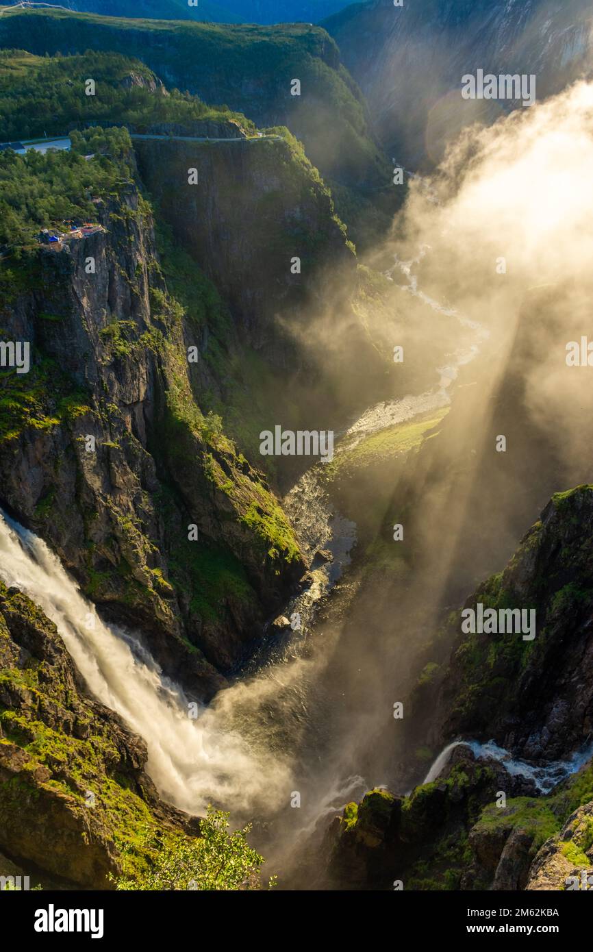 Amazing sunbeams passing through the mist created by the Voringfossen ...