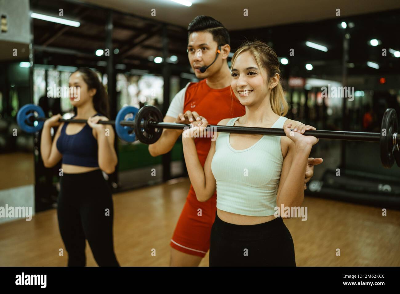 male instructor accompanies a young sporty group during exercise Stock ...