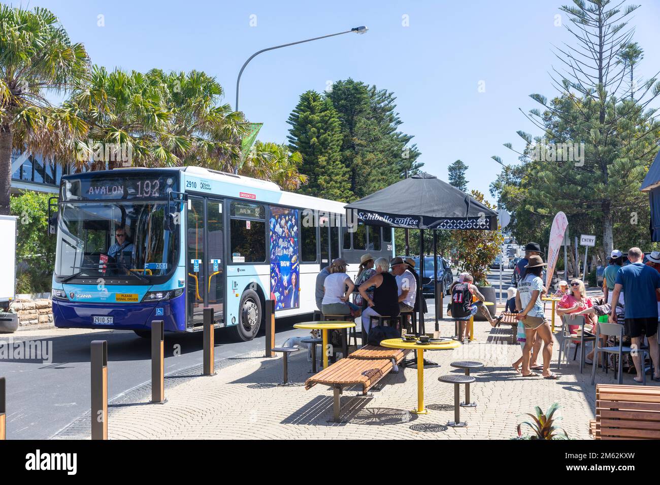 Sydney bus on one way road through Avalon Beach village centre, summers ...