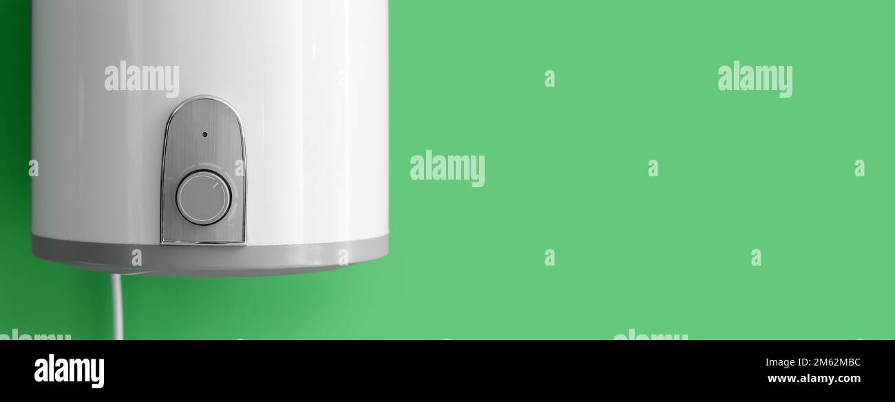 Modern electric boiler on green background with space for text Stock ...