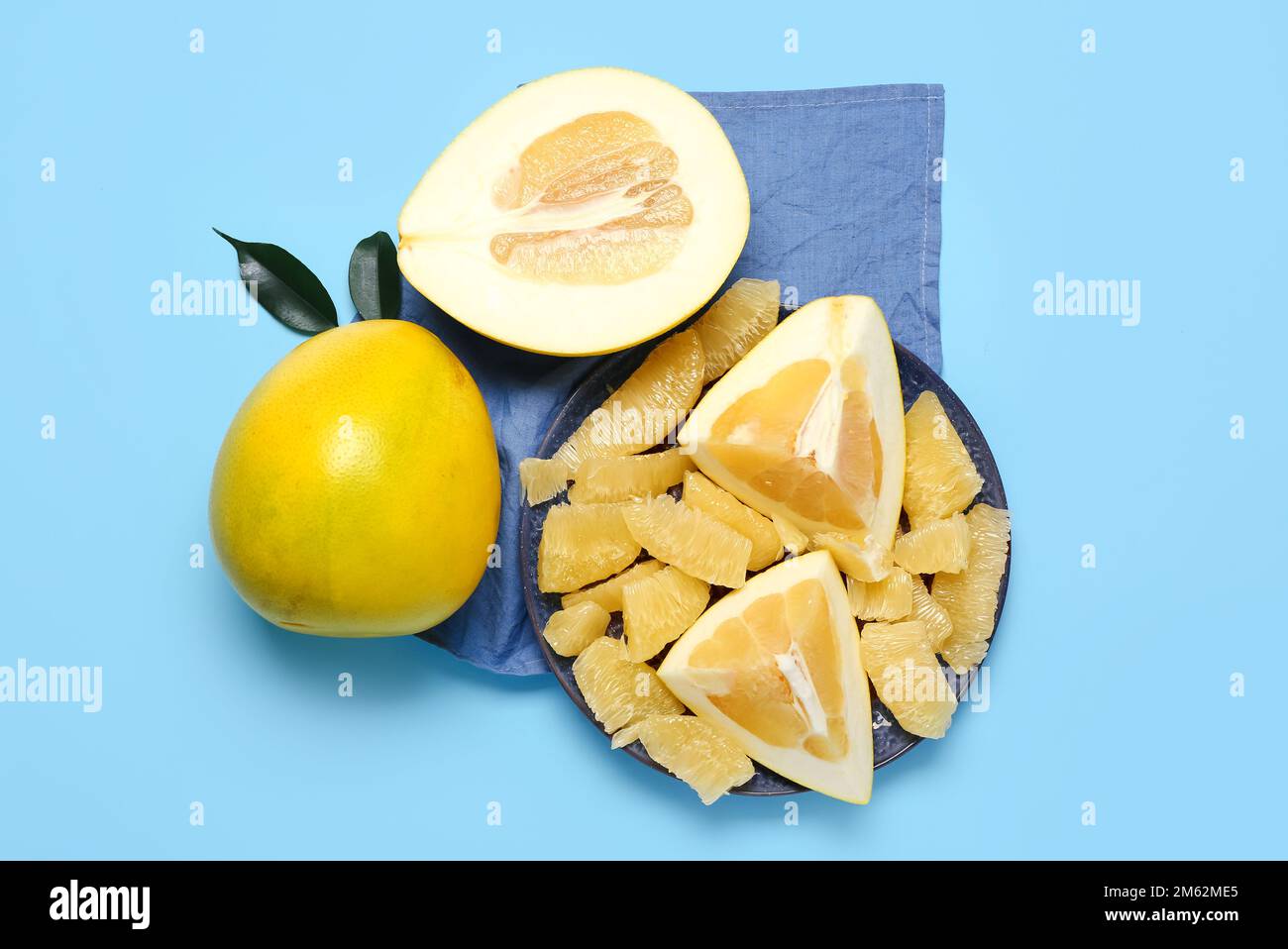 Whole and cut sweet ripe pomelo fruits on blue background Stock Photo ...