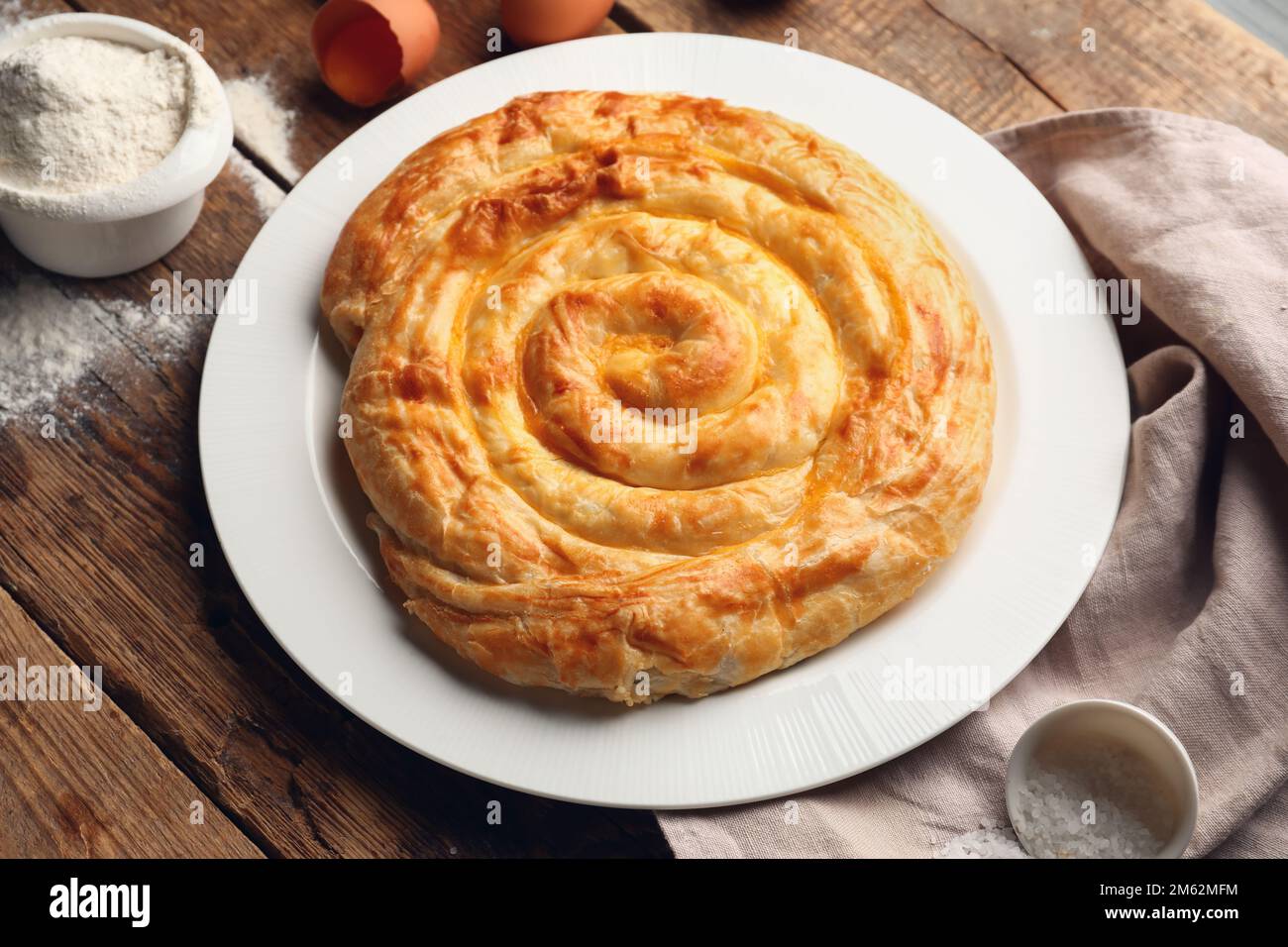 Plate with delicious cheese pie on wooden table Stock Photo - Alamy