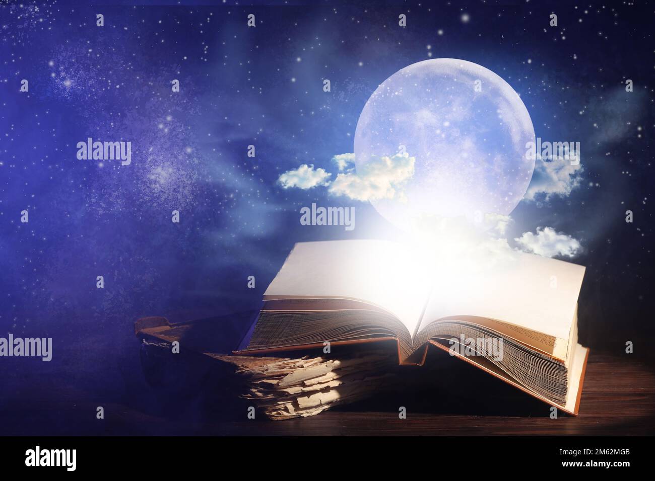 Magic books with moon and night sky on dark background Stock Photo - Alamy
