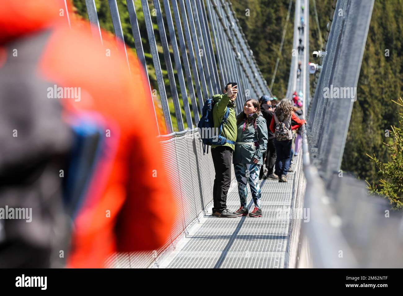 Tourists take a selfie on the world's longest suspension footbridge ...