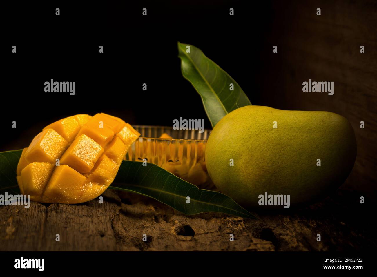 mango on a dark wood background Stock Photo - Alamy