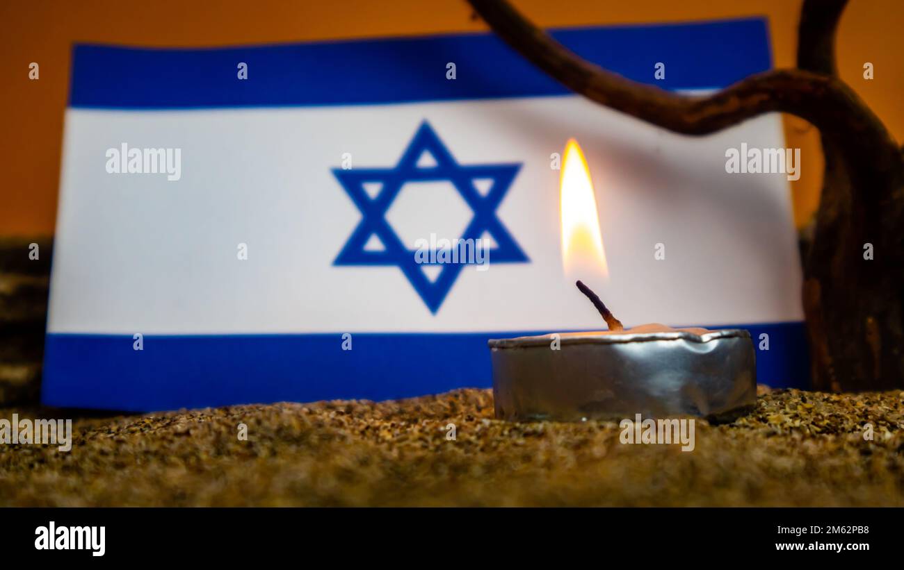 Israeli flag and burning candles in front of it, Holocaust memory day ...