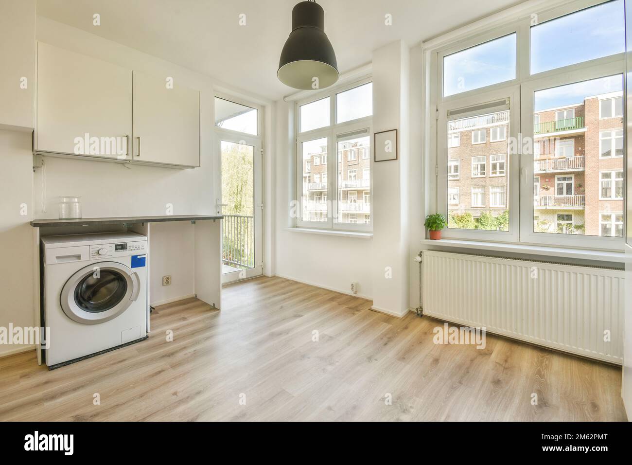 a laundry room with a washer and dryer next to the window that looks ...