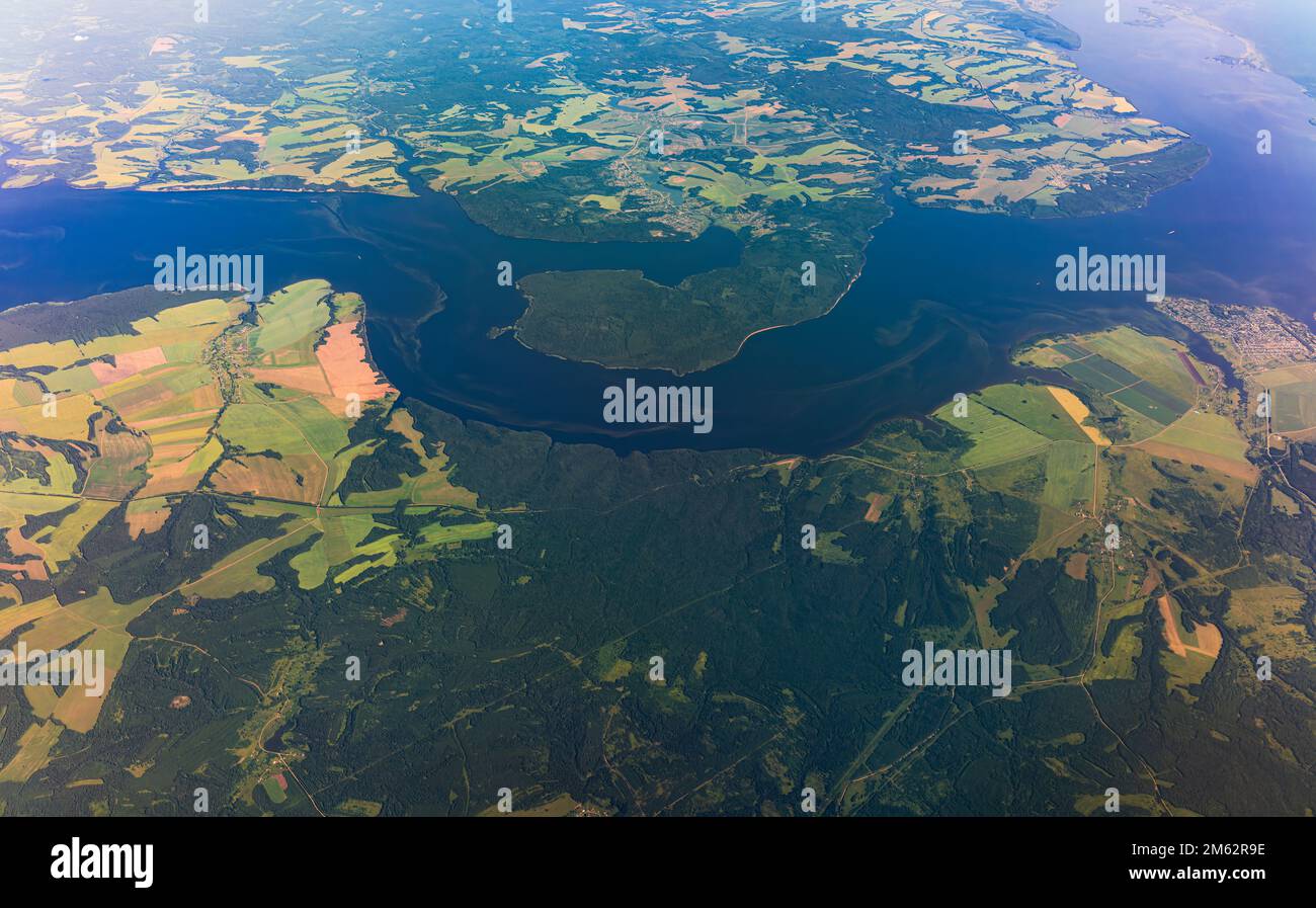 Aerial view from airplane window above green ground. View from the ...