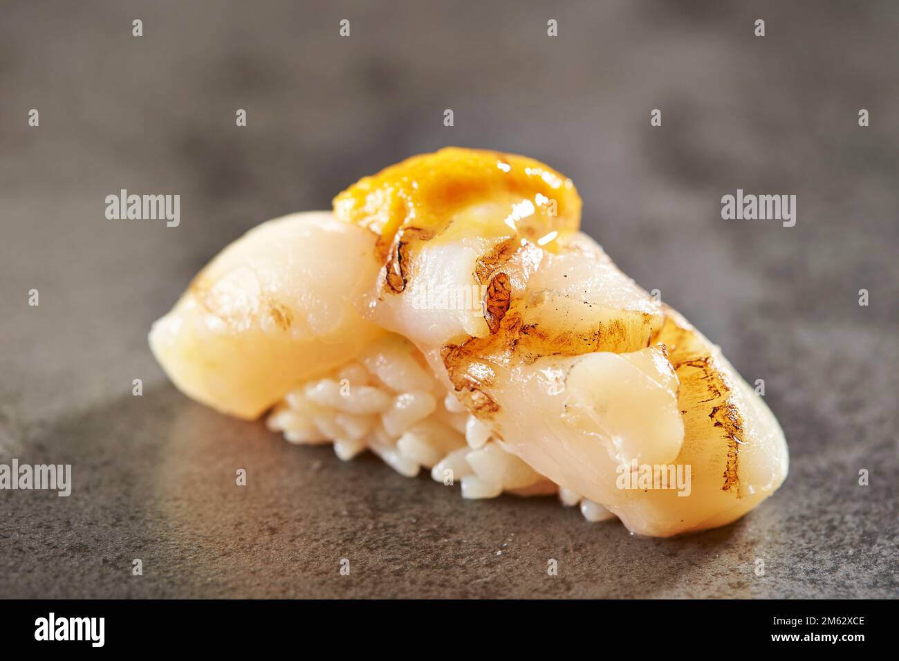 Scallop sushi close-up on gray background Stock Photo - Alamy