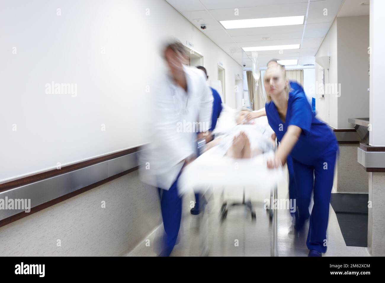 Get the OR ready, now. A group of doctors rushing a patient down the ...