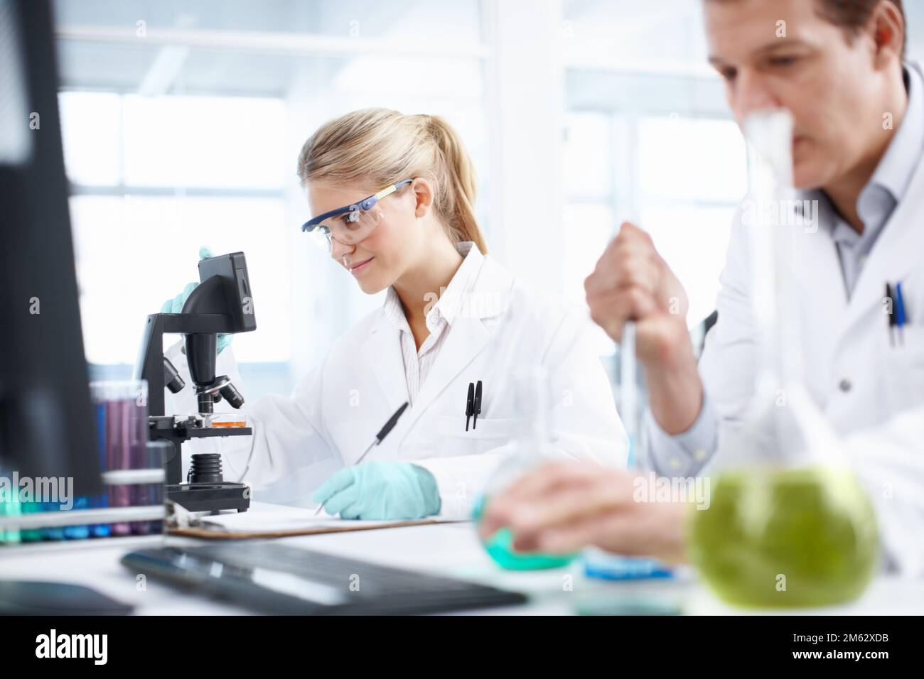 Team medical researchers analyzing samples hi-res stock photography and ...