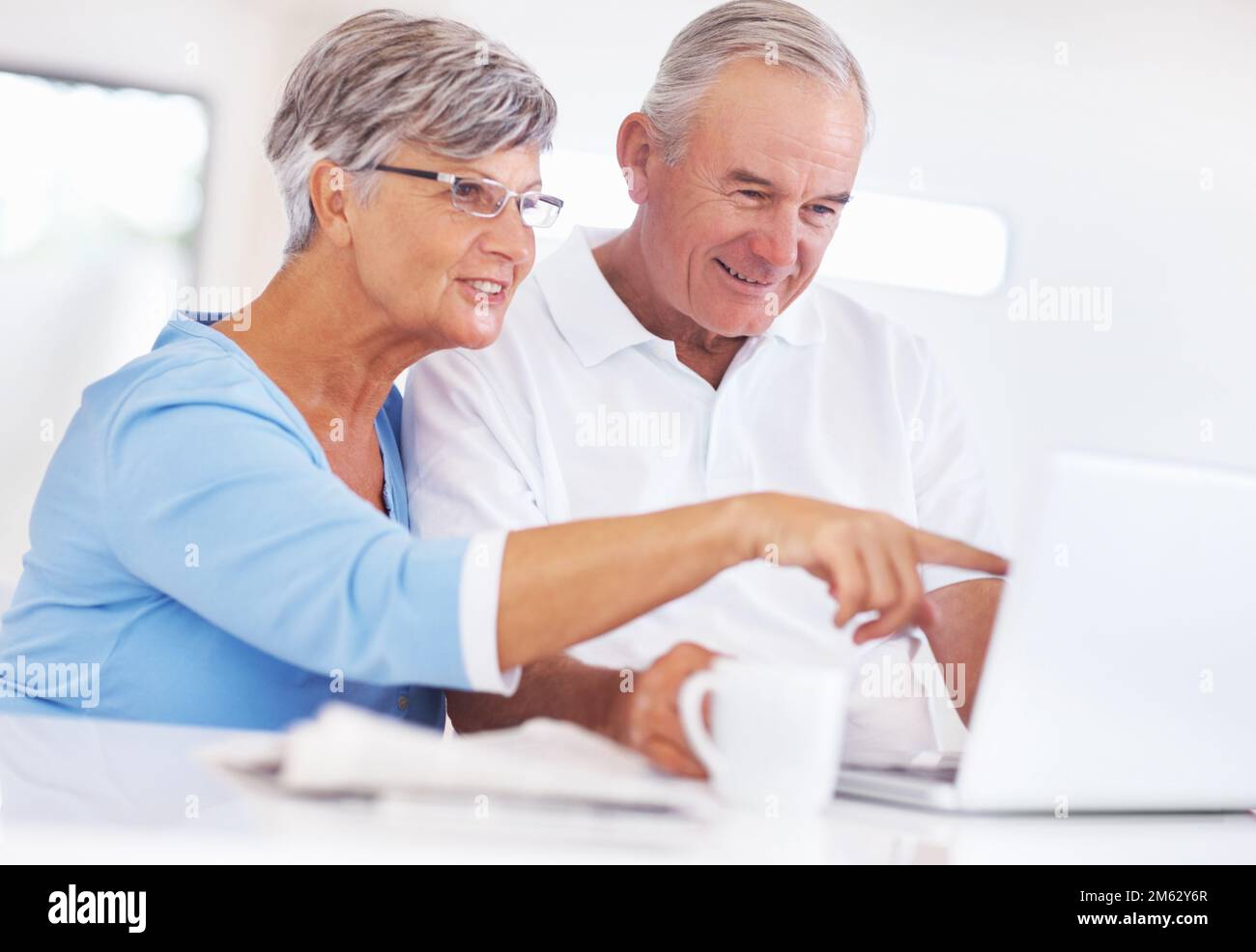 Couple using laptop. Smiling mature man using laptop with woman ...